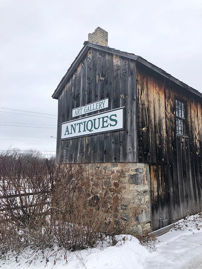 Winter can't hide the rustic beauty of this weathered barn-turned-antique haven. History lives in every wooden plank and stone foundation.