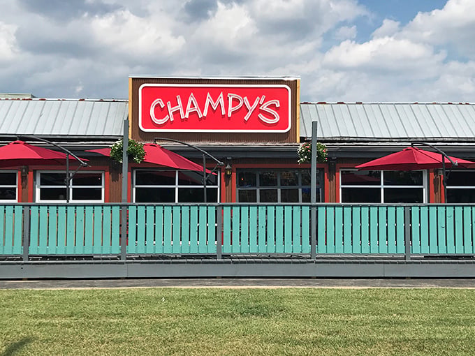 Champy's bold red sign and teal fence scream "party time!" This isn't just dinner, it's a celebration with a drumstick invitation.