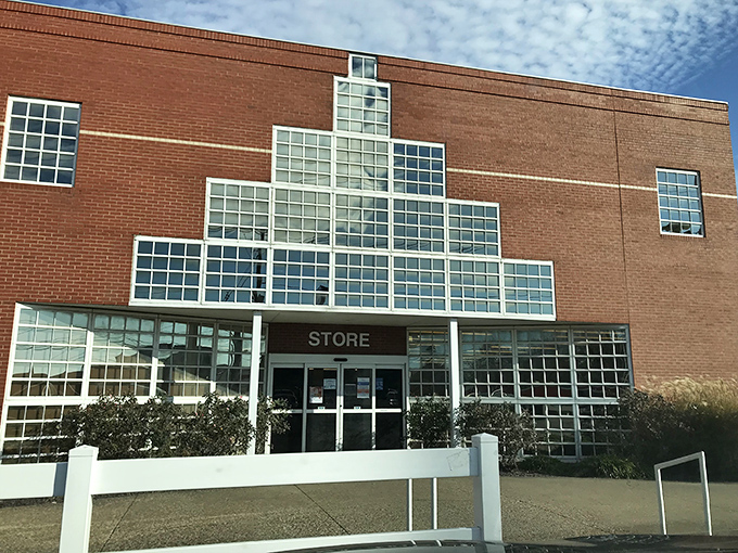 Goodwill Outlet's distinctive glass-block entrance catches the morning light. Architectural throwback meets bargain hunter's paradise.