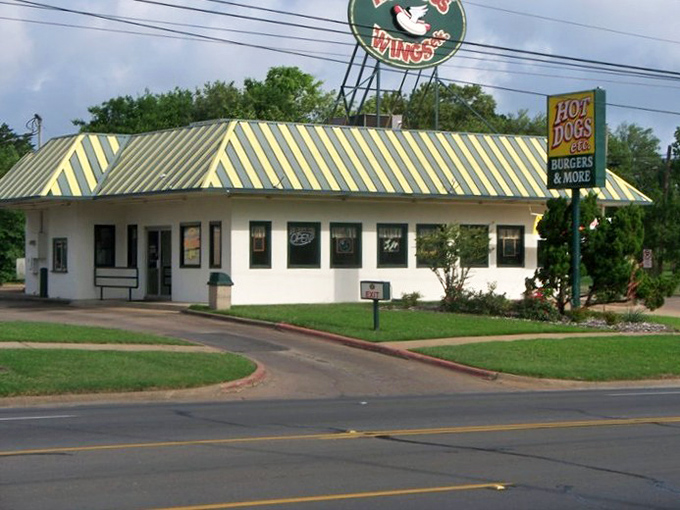 That striped yellow roof isn't just eye-catching&mdash;it's a beacon for hot dog enthusiasts who appreciate the simple perfection of a well-dressed frank.