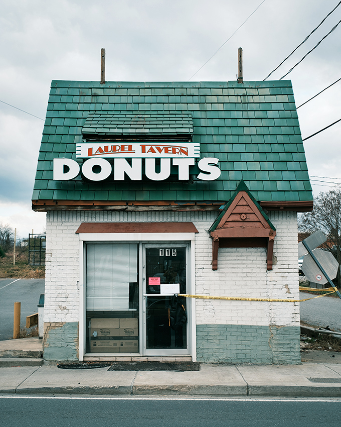 Behind that humble white exterior and glowing "OPEN" sign lies a world of old-school donut perfection that time forgot.