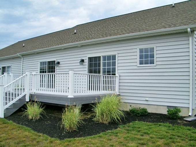 A welcoming back deck that practically begs for morning coffee and crossword puzzles. Retirement goals in white-picket perfection!