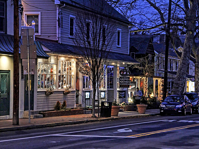 As twilight falls on New Hope, cozy storefronts glow with warmth, inviting evening strollers to linger along this charming riverside town.