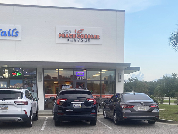 The Peach Cobbler Factory's clean, modern storefront promises sweet treasures within. No frills, just fantastic cobbler!