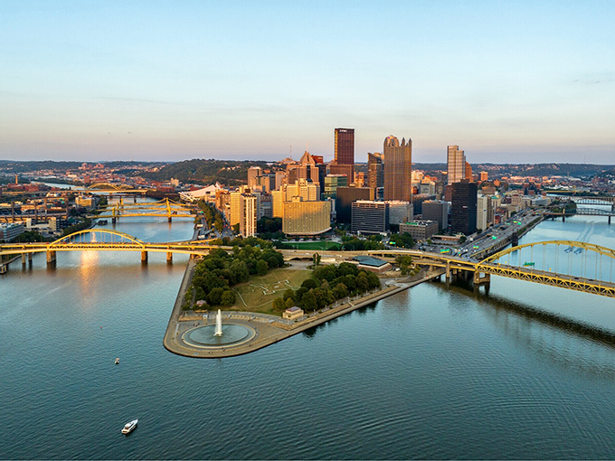 Pittsburgh's golden skyline reflects off three rivers, creating million-dollar views at Social Security prices.