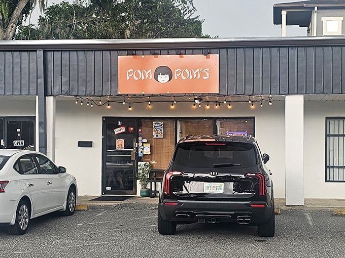 Pom Pom's bright orange sign and string lights create the kind of welcoming vibe that makes you instantly hungry.