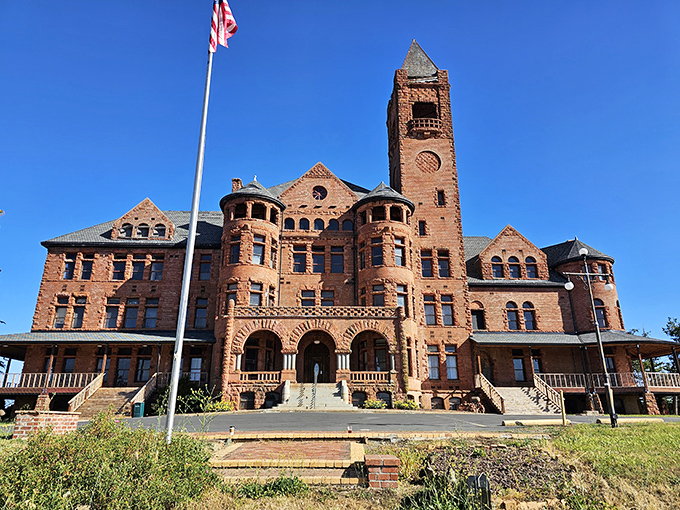 Red brick and Romanesque arches create a castle that looks like it stepped out of European history books.