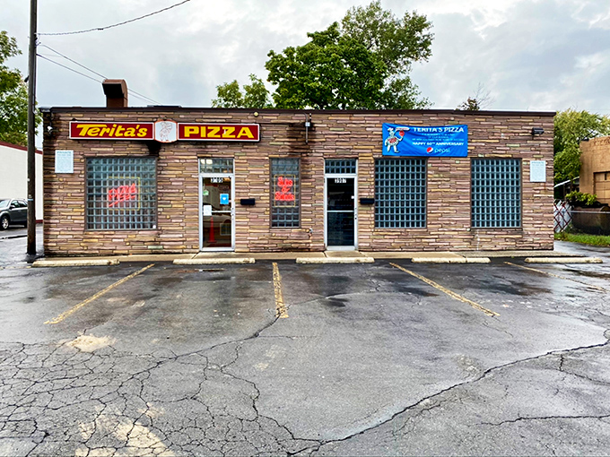 Classic brick and glass block windows signal serious pizza business happening behind these humble walls.