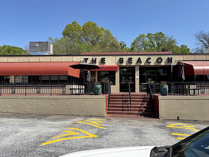 The Beacon's classic drive-in architecture whispers promises of onion rings and old-fashioned American comfort food.
