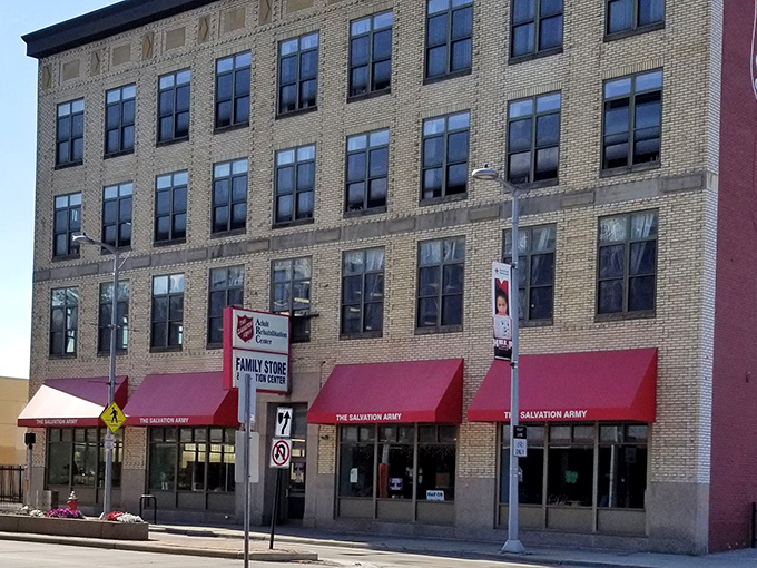 The historic Salvation Army building stands tall in Cleveland, its red awnings like welcome mats to a world of second-hand treasures.
