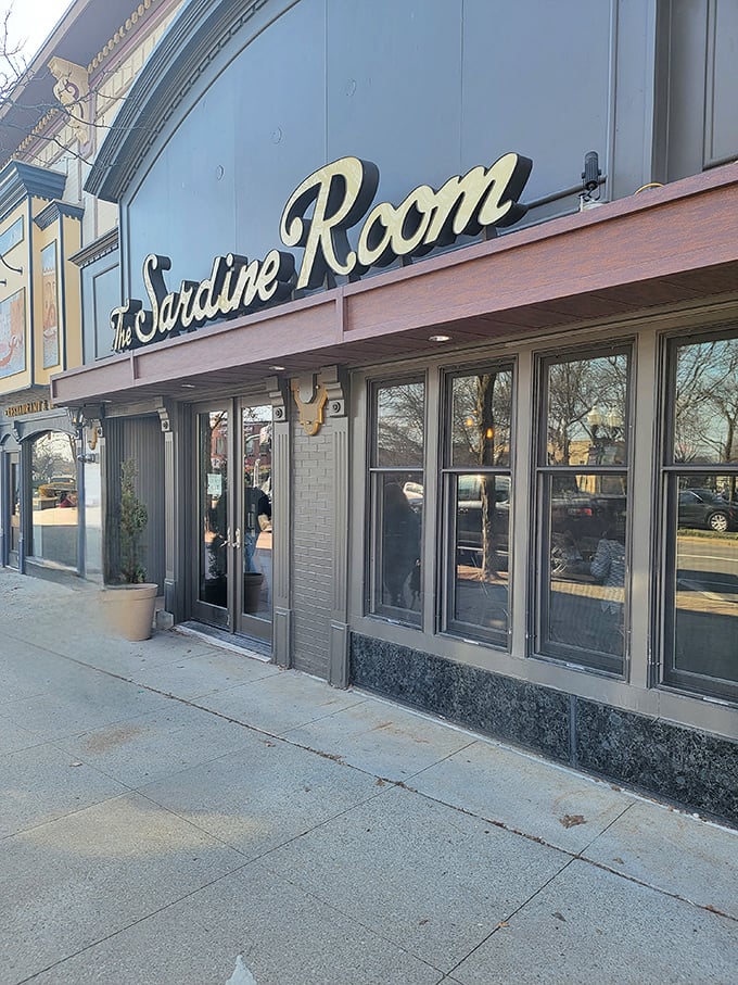 The Sardine Room's elegant script beckons like an old friend sharing secrets about the catch of the day.