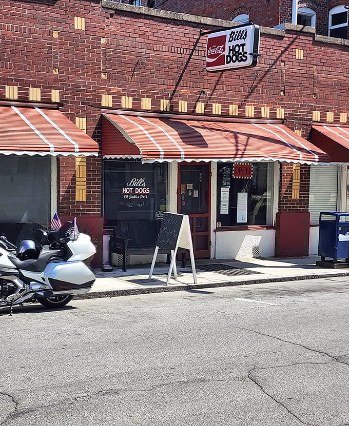 The striped awnings of Bill's Hot Dogs offer a splash of color against classic brick. Simple pleasures in a small-town package.