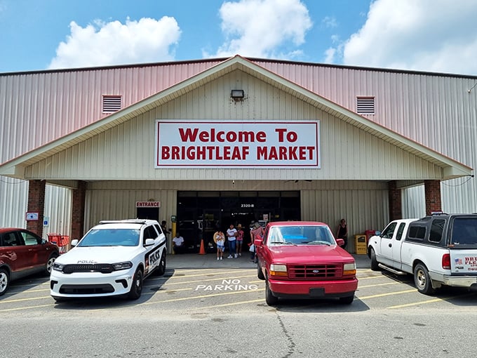Shoppers eagerly approach Brightleaf's entrance, drawn like moths to the flame of fantastic finds. The parking lot's already filling with bargain hunters!