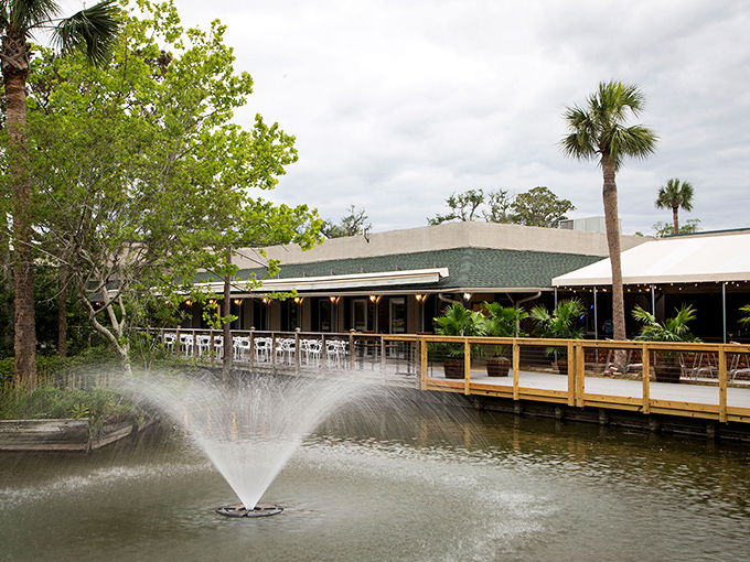 A relaxing afternoon at The Coligny Cafe awaits you, featuring peaceful fountain views and comfortable seating along the scenic wooden deck.