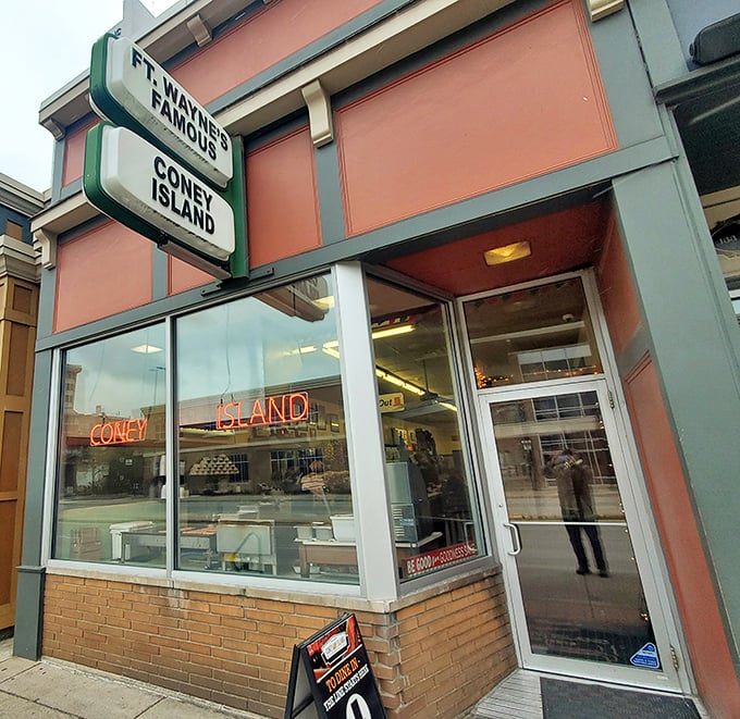 The neon "CONEY ISLAND" sign has guided hungry locals for generations. Simple storefront, extraordinary dogs - that's the Fort Wayne way.