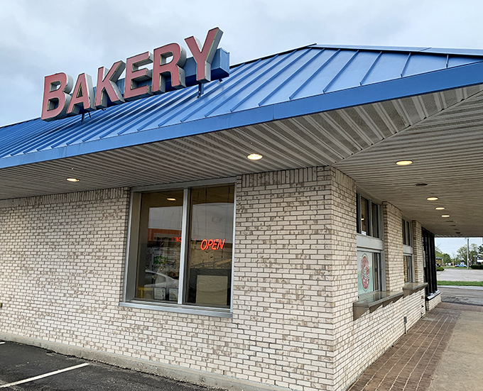Simple brick, bold letters, and a blue roof &ndash; the architectural equivalent of "we don't need fancy, our donuts speak for themselves."