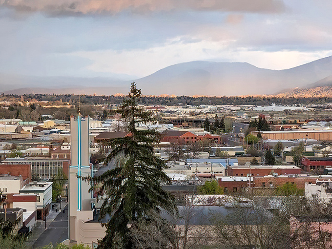 Mountain vistas frame your view of Klamath Falls, where historic architecture meets the glowing warmth of a quiet, scenic sunset.