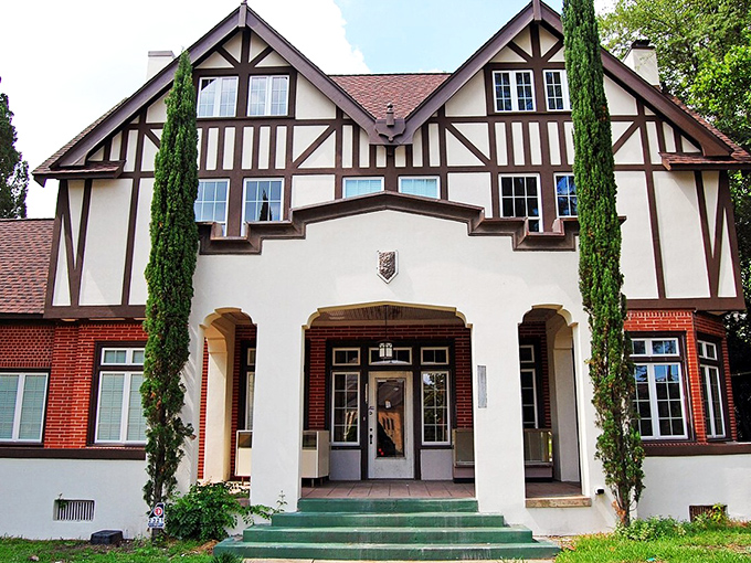 Tudor elegance with a Georgia twist! This Macon mansion looks like it teleported from Shakespeare's England, cypress trees standing guard like royal sentinels.