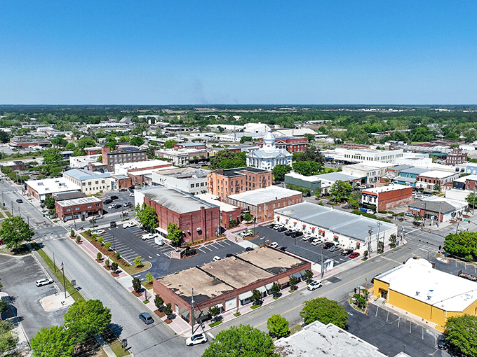 Aerial view of a charming Georgia town center where historic architecture meets modern gatherings, showcasing the heart of small-town community life.