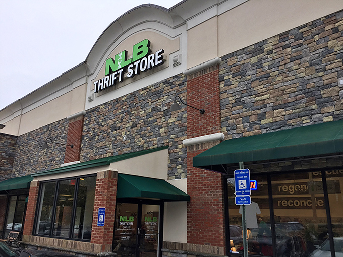 That green awning welcomes bargain hunters into a world where designer dreams meet thrift store prices.
