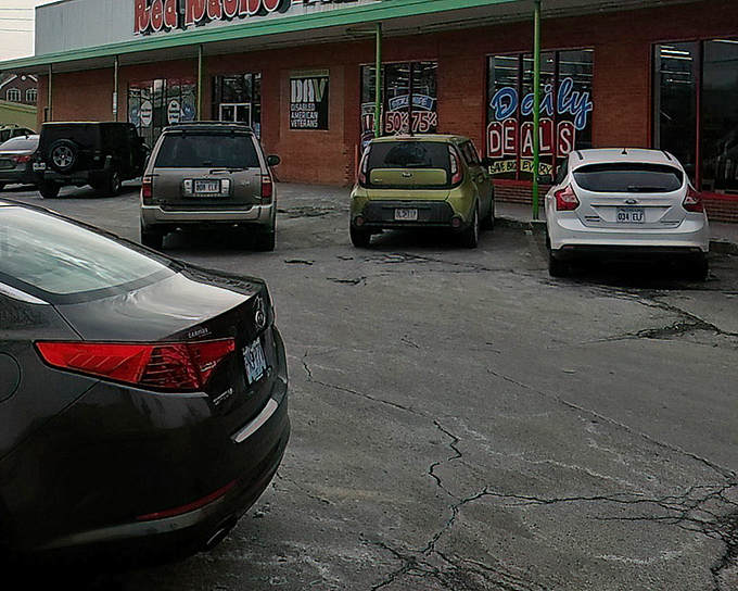 Daily Deals flash in neon from Red Racks' windows, a siren song for savvy shoppers cruising by in search of bargains.