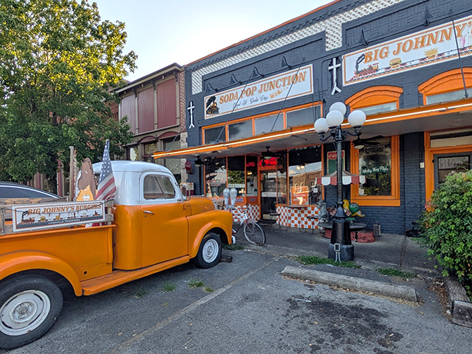That vintage orange truck out front isn't just decoration; it's a promise of authentic Americana inside.
