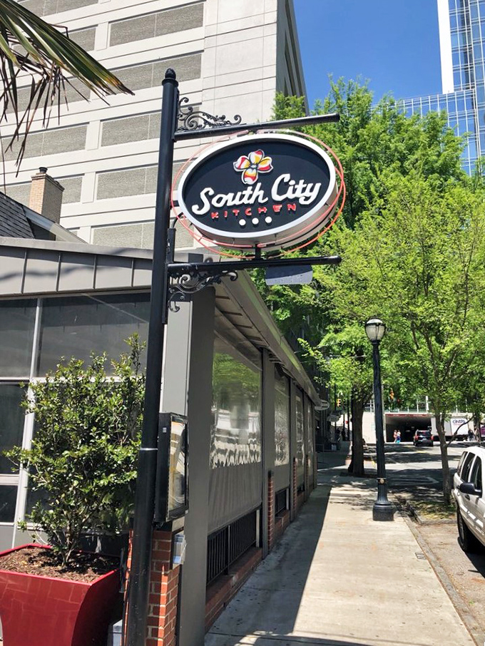The distinctive South City Kitchen sign beckons hungry Atlantans like a culinary lighthouse amid the Midtown skyscrapers.
