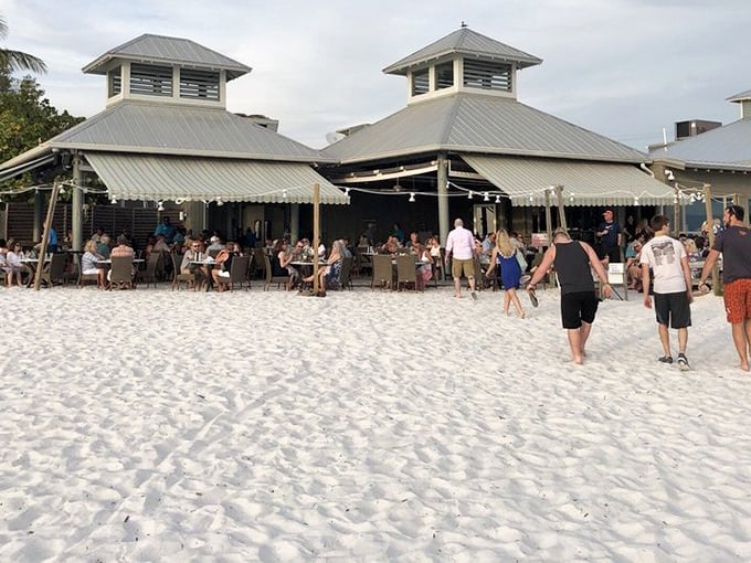 Who needs floors when you have sand? The Sandbar's breezy pavilions and string lights create the perfect setting for barefoot dining as beachgoers stroll by.