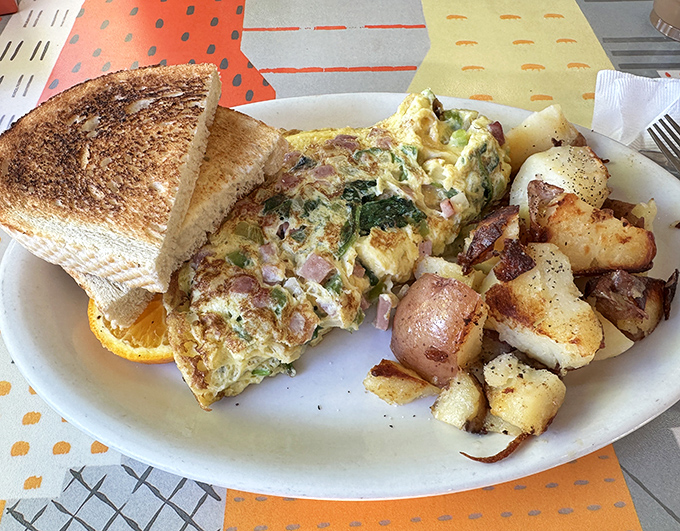 This isn't just breakfast; it's edible therapy. A perfectly executed omelet with home fries that could make a potato farmer weep.