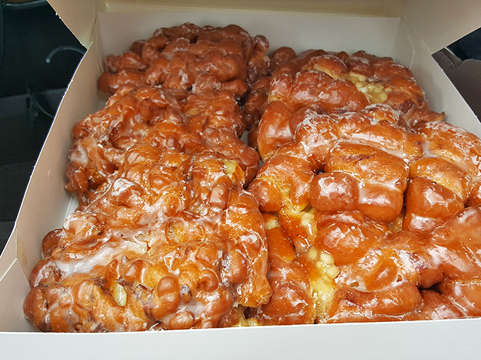 These apple fritters aren't just fried dough &ndash; they're glistening monuments to what happens when apples, cinnamon, and glaze achieve perfect harmony.