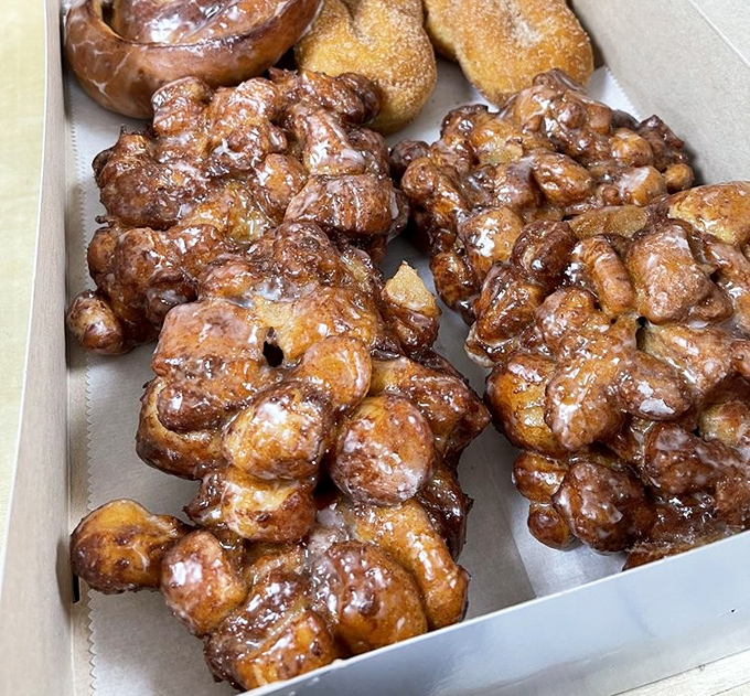 Behold the apple fritters in their natural habitat &ndash; gloriously misshapen, glistening with glaze, and absolutely unapologetic about their caloric content.