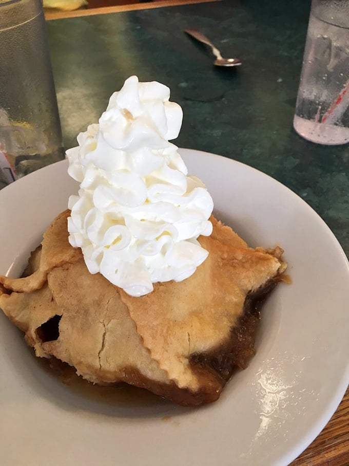 The apple dumpling arrives like a warm hug on a plate &ndash; flaky pastry, tender fruit, and that mountain of whipped cream that says "diet tomorrow, indulge today."