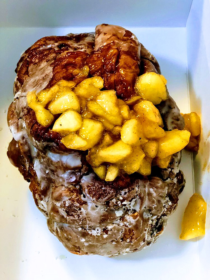 Behold the legendary apple fritter&mdash;a glorious mountain of glazed, apple-studded pastry. This isn't just a donut; it's architecture with cinnamon.