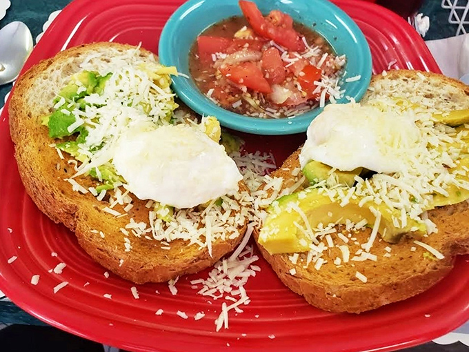 Avocado toast perfection: creamy green goodness on hearty bread, topped with melty cheese and served with a side of homemade salsa. Worth crossing Pennsylvania for.