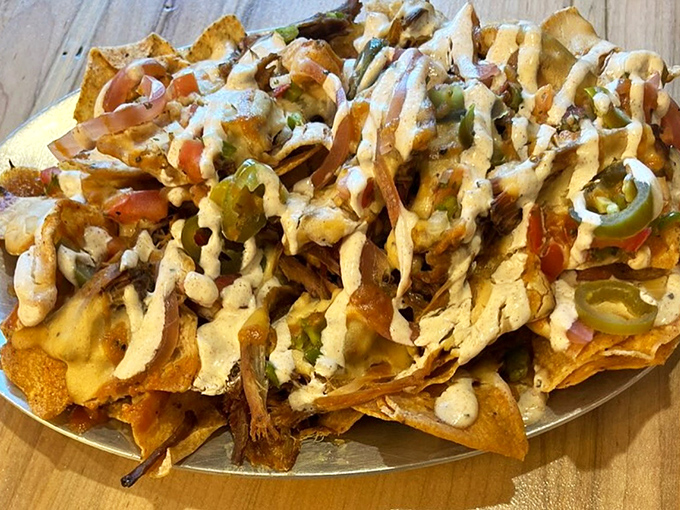 BBQ nachos that could make a vegetarian weep with temptation. Layers of pulled pork, jalape&ntilde;os, and cheese sauce creating a perfect storm of flavor. 