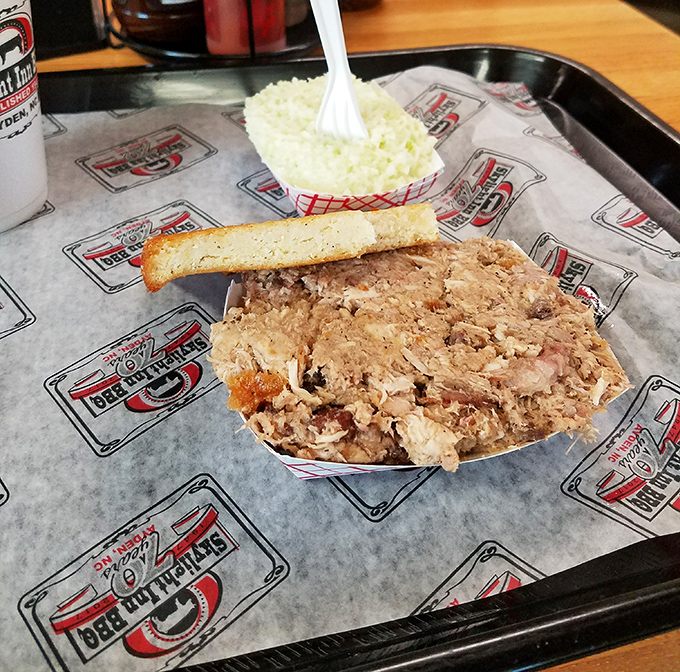 Eastern Carolina barbecue in its purest form&mdash;chopped pork with bits of cracklin' skin, a thin slice of cornbread, and vinegar-based slaw. Poetry on a paper tray.
