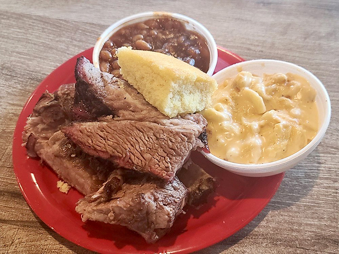 Brisket with that perfect pink smoke ring alongside mac and cheese and baked beans. This plate isn't just lunch&mdash;it's a Southern symphony.