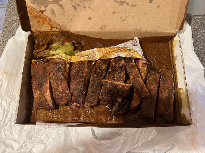 These ribs aren't just falling off the bone&mdash;they're practically jumping into your mouth, swimming in that signature sauce that's worth the trip alone.