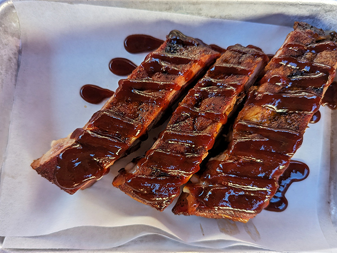 Behold the holy grail: ribs so tender they practically surrender to your fork, glistening with barbecue sauce perfection.
