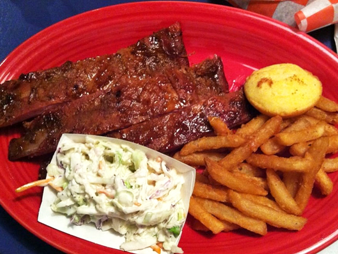 Ribs with that perfect mahogany bark, coleslaw for tang, and golden fries. This isn't just dinner&mdash;it's edible architecture built for maximum pleasure.