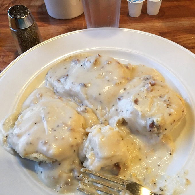 Biscuits and gravy that would make your Southern grandmother weep with joy. Peppery cream gravy cascades over fluffy biscuits like a savory waterfall.