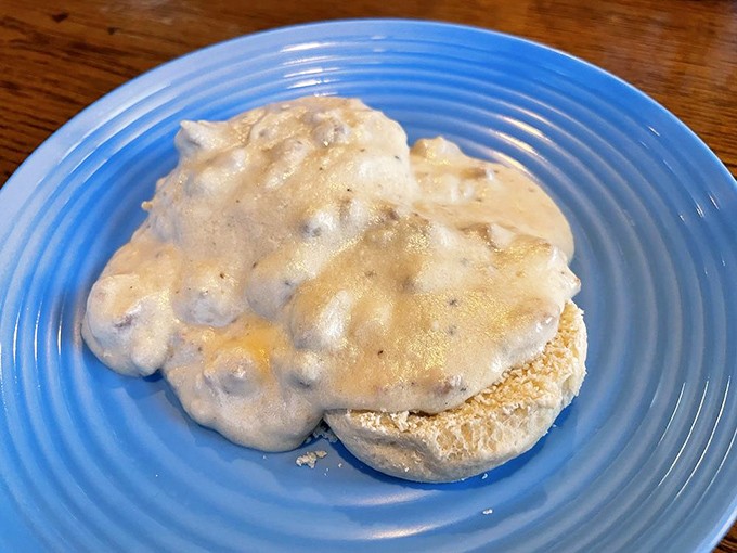 Behold the star attraction: biscuits smothered in velvety sausage gravy. This isn't just breakfast&mdash;it's an Ohio morning tradition served on a blue plate.