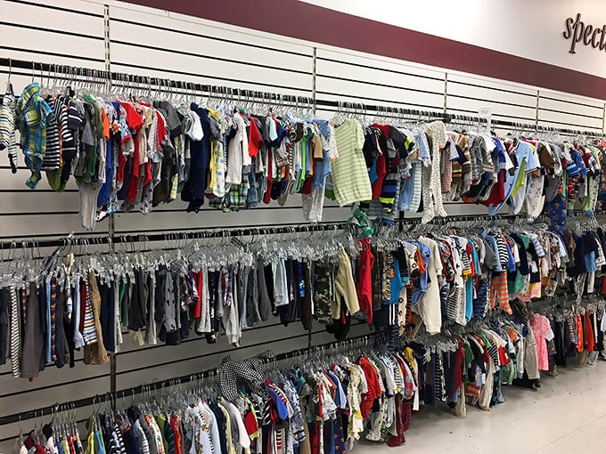Tiny fashionistas start here! Row upon row of baby clothes waiting for their second act on a new generation of drooling critics.