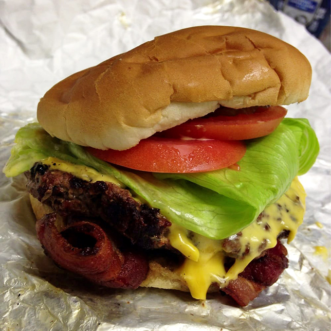 This burger could double as a paperweight, if you weren't too busy devouring every glorious, cheese-dripping layer.
