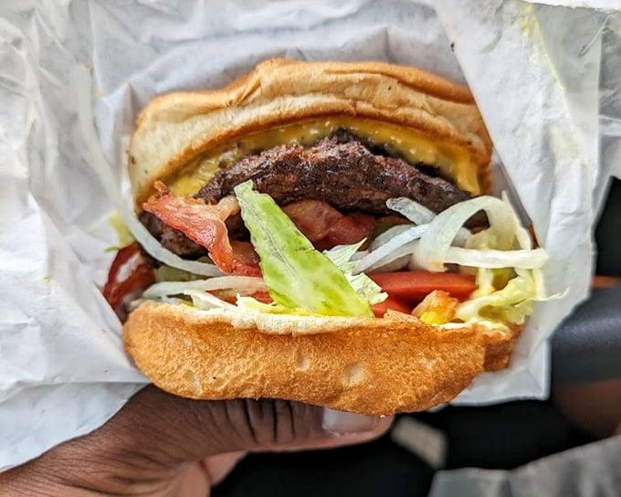 Behold the bacon cheeseburger in its natural habitat&mdash;wrapped in paper, bursting with toppings, and destined to make your car smell heavenly.