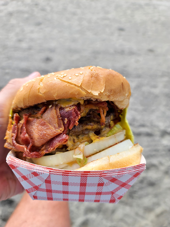 Behold the star of the show: layers of beef, bacon, and cheese creating what can only be described as a hand-held miracle.