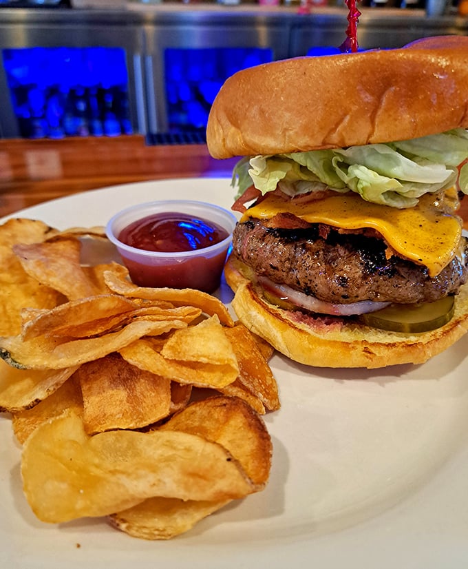 Behold burger perfection&mdash;a towering masterpiece of beef, cheese, and fresh toppings alongside homemade chips that shatter with each satisfying crunch.