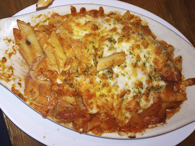 Behold the legendary baked ziti&mdash;pasta tubes nestled in rich tomato sauce under a blanket of melted cheese that stretches with each forkful like an Italian tug-of-war.