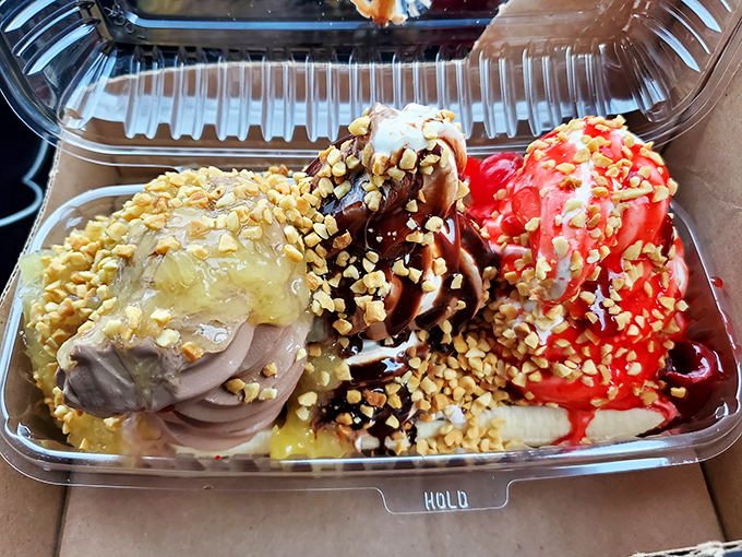 This banana split isn't just dessert; it's architecture. Three distinct neighborhoods of flavor, connected by caramel highways and nut boulevards.