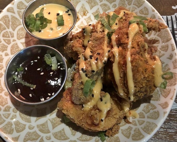 The legendary Bang Bang Chicken arrives like a crispy golden masterpiece, drizzled with sauces that make your taste buds perform a standing ovation.